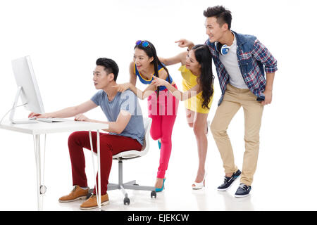 Exciting young people looking at computer monitors Stock Photo - Alamy