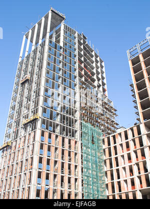 A building under construction with huge windows and gray walls inside ...