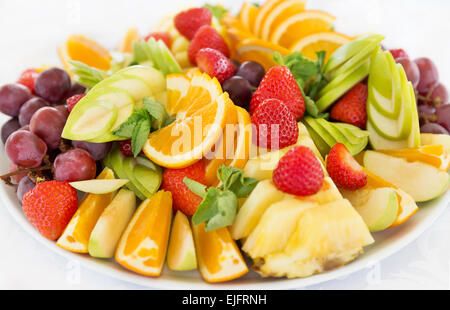 fresh mixed fruits on plate over white background Stock Photo - Alamy