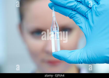 female doctor holding a vial Stock Photo - Alamy