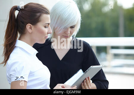 Two business woman with tablets Stock Photo - Alamy