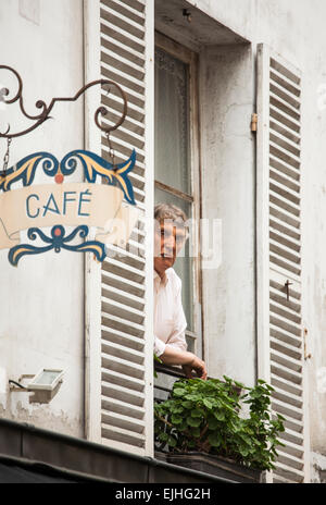Man smoking out window in Montmartre, Paris, France Stock Photo - Alamy