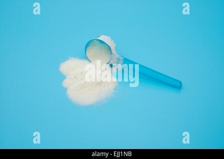 powdered milk in a blue spoon on pink background, closeup Stock Photo ...