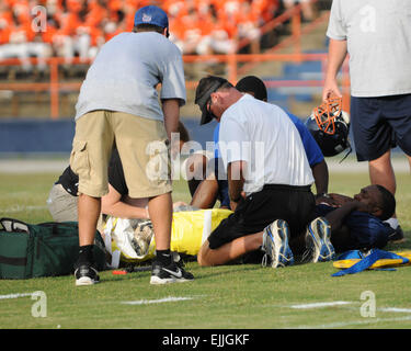 Medical personnel transport injured football player off the field on a ...