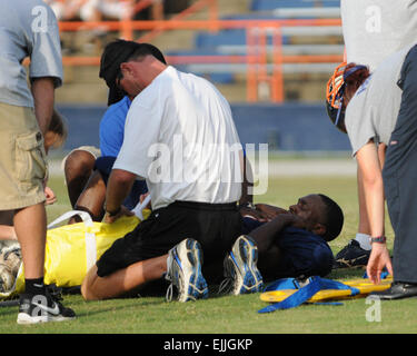 Medical personnel transport injured football player off the field on a ...