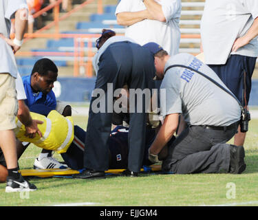 Medical personnel transport injured football player off the field on a ...