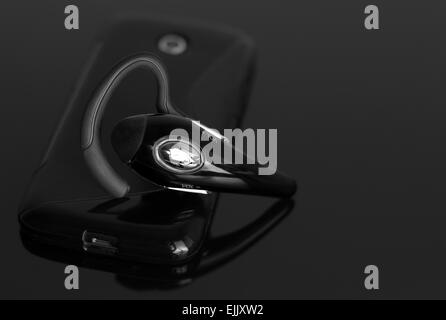 Close-up of mobile handsfree bluetooth device Stock Photo - Alamy