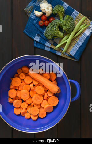 A vertical shot of fresh sliced green apples with shadow from window ...