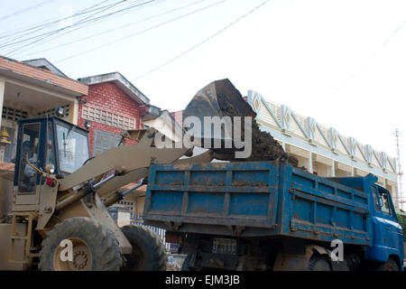 Dump truck dumping dirt on landfill Stock Photo - Alamy