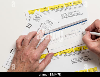 Male caucasian hands writing check to Internal revenue service IRS form ...