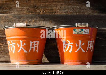 Two old orange Japanese fire buckets at a Buddhist temple in Nara ...