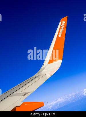 easyjet plane wing in blue sky with clouds Stock Photo - Alamy