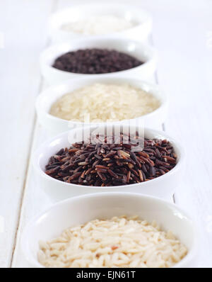 Different kind of raw rice, raw rice in the white bowls Stock Photo - Alamy