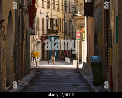 A man walks past apartments buildings damaged by shelling in Kramatorsk ...