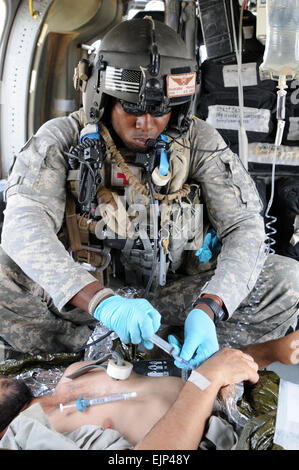 A US Army flight medic and an Afghan National Army commando are hoisted ...