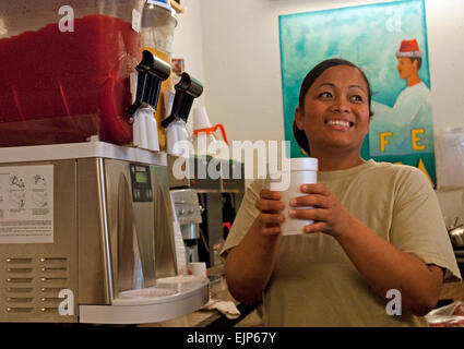 Spc. Letti Togia of the 664th Field Artillery Battalion serves coffee ...