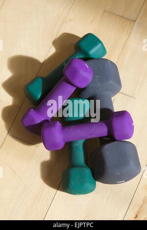 small dumbbell weights on gym floor Stock Photo - Alamy