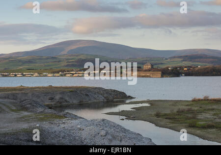 View of flooded former iron ore mining area, surrounded by sea wall on ...