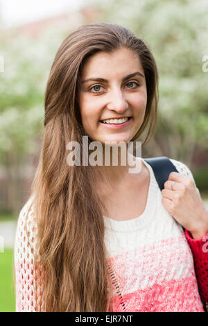 Image of a smiling happy student lady outdoors in nature green park ...