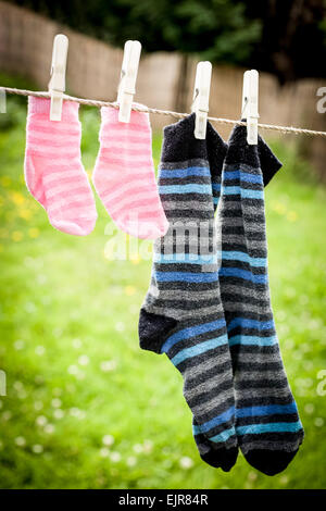 Baby socks on clothesline for drying Stock Photo - Alamy