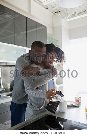 Casual couple hugging and smiling Stock Photo - Alamy