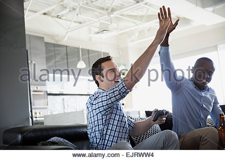 Men high fiving Stock Photo - Alamy