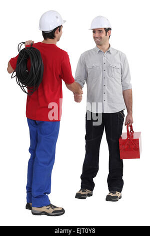 Electricians greeting each other Stock Photo - Alamy