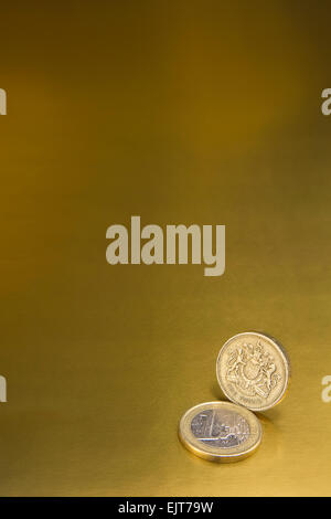 One Euro coins and British one pound coins isolated on a plain white ...