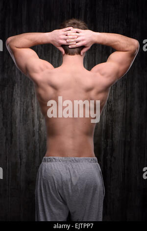 Back view of well formed man demonstrating biceps Stock Photo - Alamy