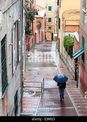 People walk under the rain in front of the Duomo gothic cathedral, in ...