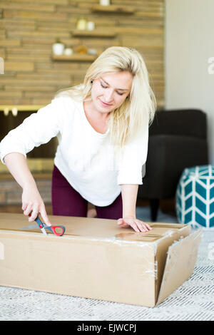 woman opening cardboard box Stock Photo - Alamy