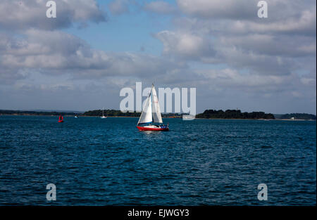 Yacht sailing near Sandbanks and Shell Bay at the entrance to Poole ...