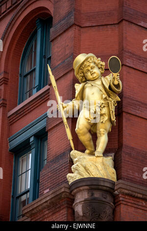 A golden statue of Puck on the corner of the Puck building in the ...