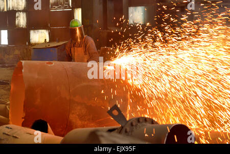 Using gas torch to cut steel reinforcing bars in concrete structure ...