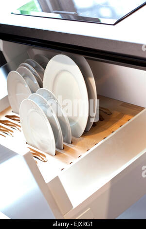 Plates in kitchen drawer Stock Photo - Alamy