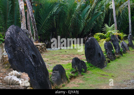 Stone money (Rai stones) in the bank, hands extending from the hole in ...