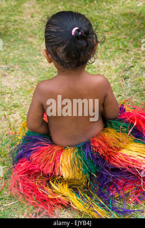 Little Yapese girl in traditional clothing holding coconut at Yap Day ...