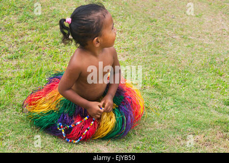 Little Yapese girl in traditional clothing holding coconut at Yap Day ...