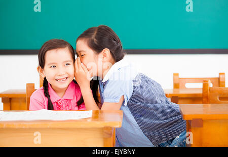 Student, friends and whisper in classroom for secret, gossip or ...