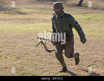 Re-enactor in Third Reich's World War II SS uniform playing with ...