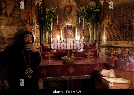 A Coptic Orthodox priest sits inside the small Coptic Chapel which contains and altar and the ...