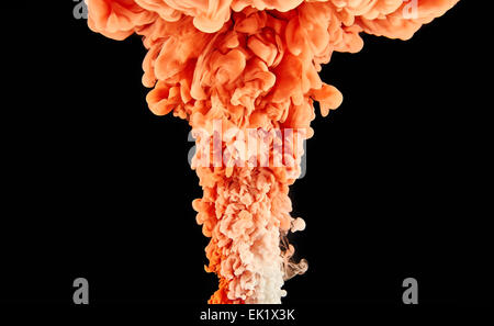 Clay colored ink making smoke patterns in water on black background ...