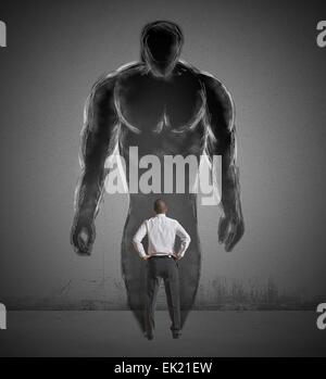 Businessman and shadow of strong muscular man behind him on white ...
