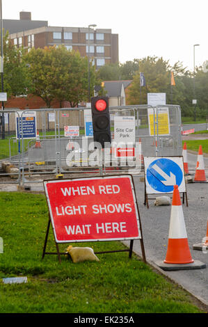 when red light shows wait here stop signs next to portable traffic ...