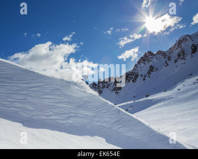 freeride skier skiing downhill during sunny day in high mountains, an ...