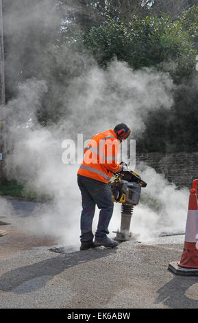 Tarmac machine laying new tarmac on a street in Norwich Stock Photo - Alamy