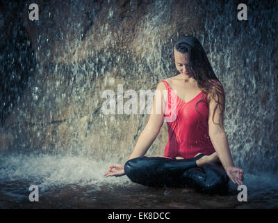Beautiful young woman practicing Padmasana on yoga mat at home. Lotus ...