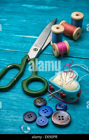 thread buttons for crafts on turquoise wooden background.Selective ...