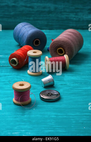 thread buttons for crafts on turquoise wooden background.Selective ...