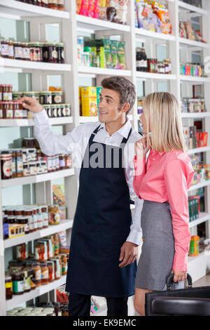 Employee helping a customer Stock Photo - Alamy